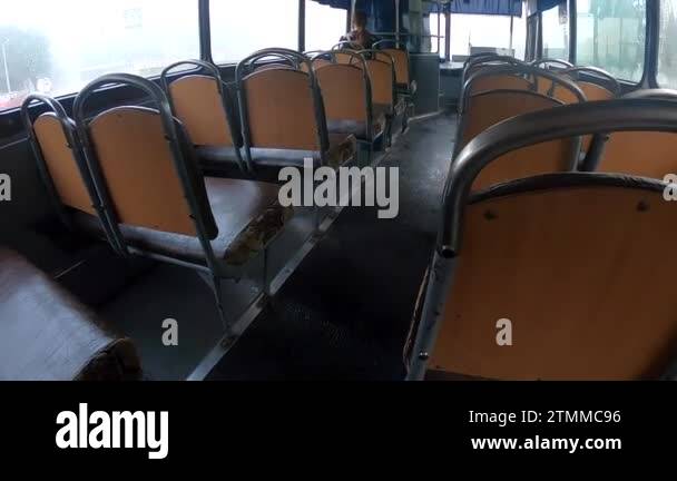 Man riding bus. Woman sitting on seat and riding inside empty old ...
