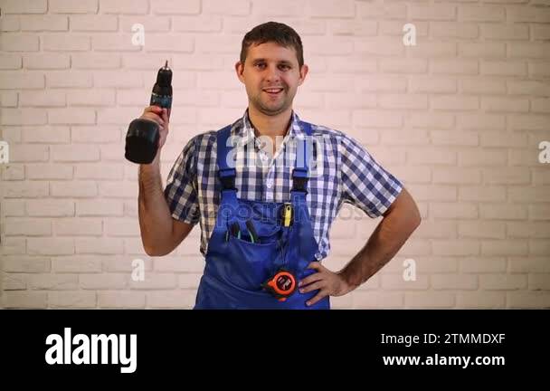 A man with a screwdriver. Worker repairman, builder of the working suit ...