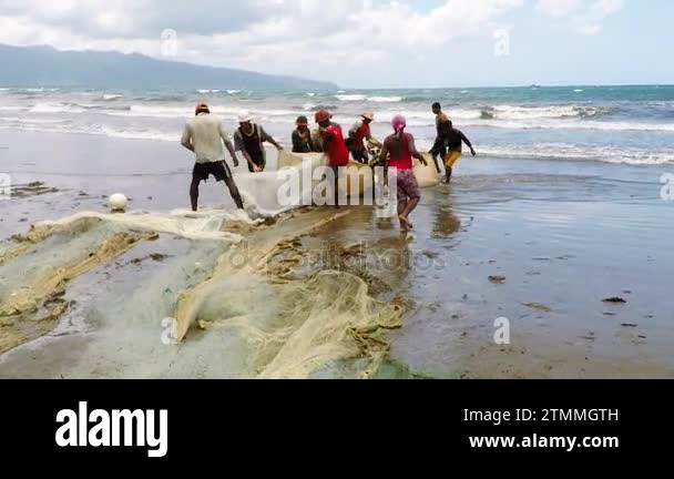 Native fishermen fishing on sea, using traditional technique pulling ...