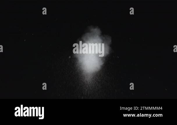 4K slow-motion dramatic dusty bullet hit on a black wall. Explosive ...