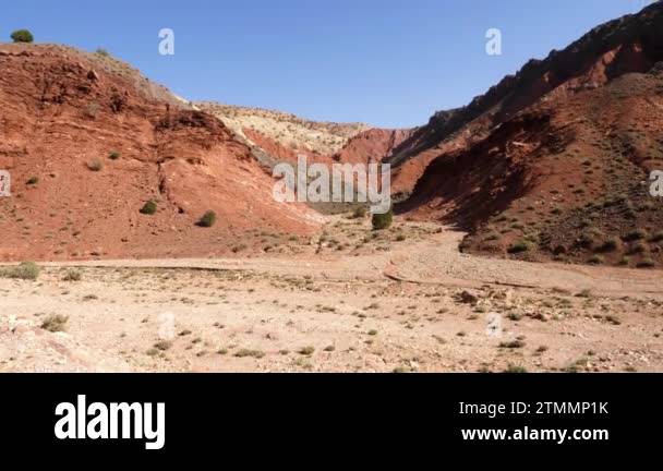 Abstract red mountains rocks and dry river in the Ounila Valley, High ...