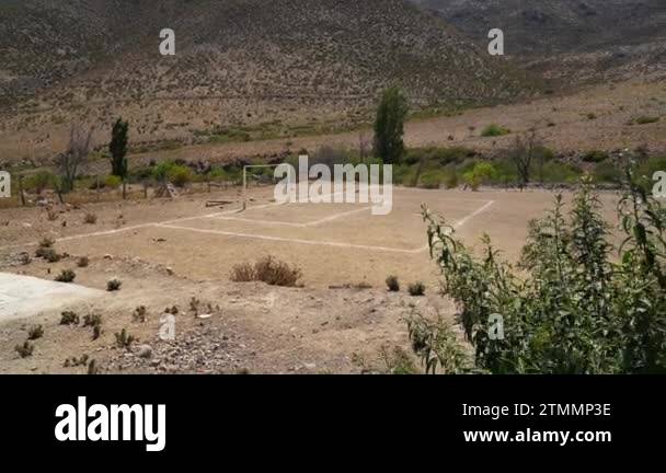 Soccer field or football pitch with goal and white lines in the dry and ...