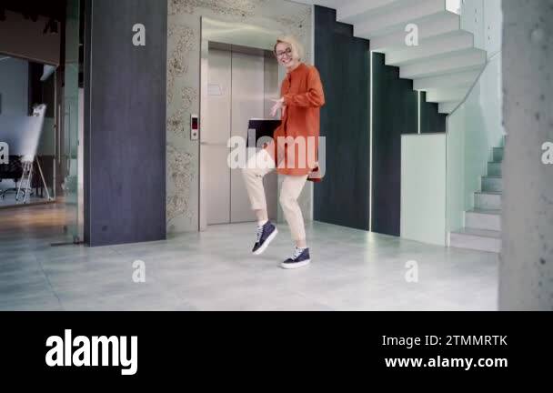 Happy joyful young and attractive woman dancing victory dance in ...