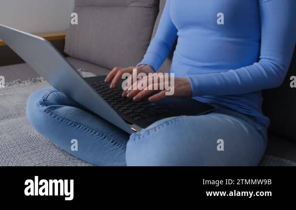 Female typing text on a laptop keyboard at home. Overworked freelancer ...