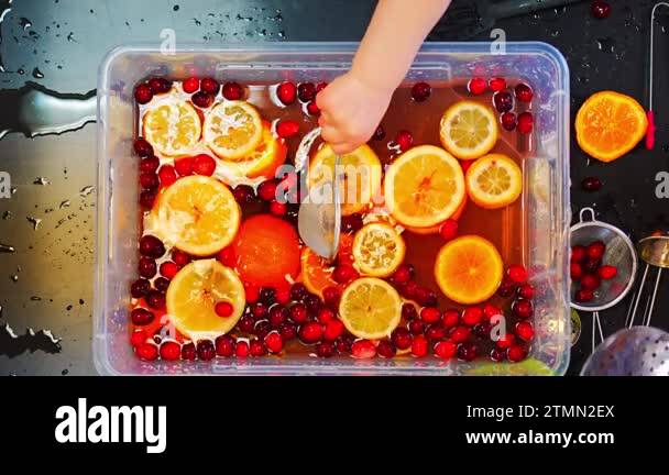 Kids playing in handmade fruit bar with kitchenware, berries and citrus fruits. Sensory ...