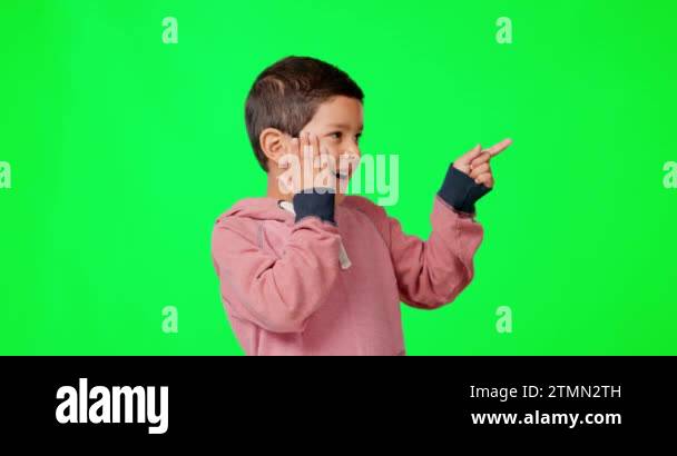 Surprise, pointing and notification with a boy on a green screen ...