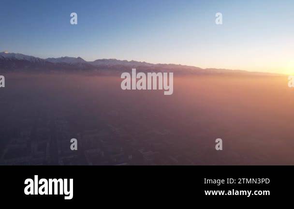 Epic gray smog is visible at sunset over the city. A birds-eye view ...