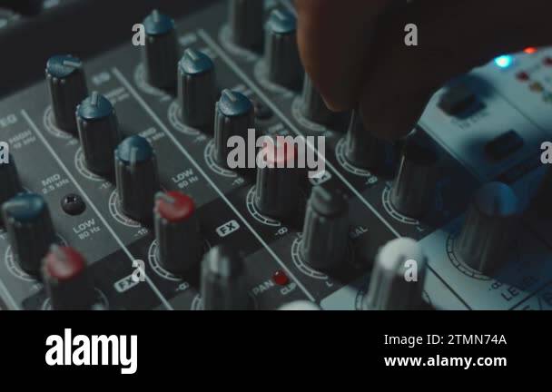 Close-up of fingers adjusting sound mixing console. Mixer console for ...