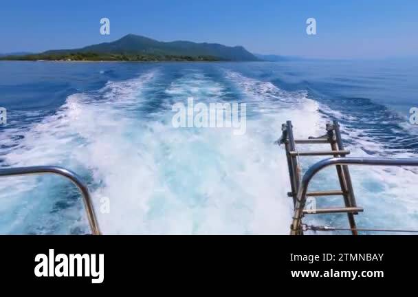 Sailing ship day rear POV view looking to the blue sea with low-rise ...