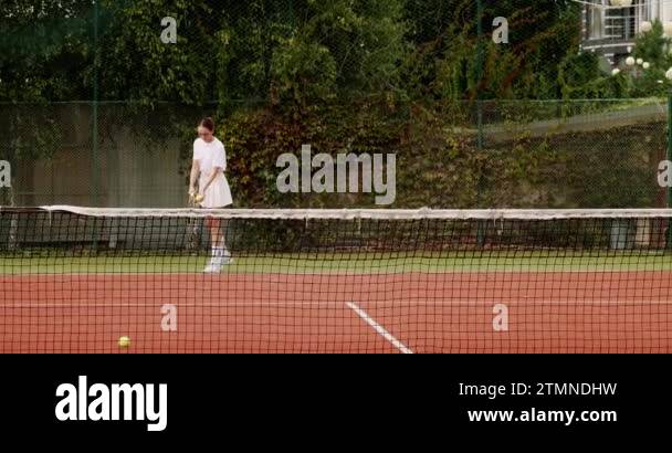 Woman play tennis on carpet court outdoors. A woman play tennis ...