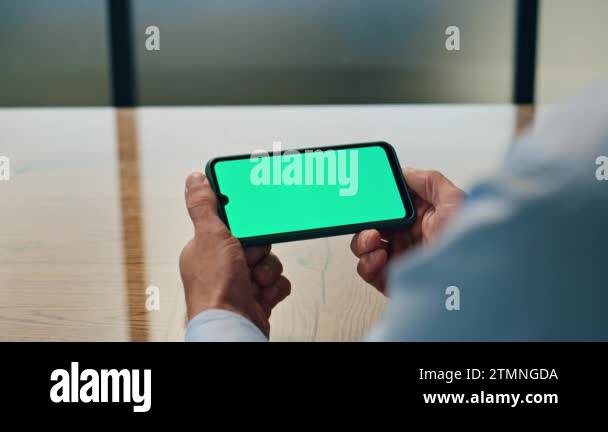 Businessman hands watching chromakey device in workplace close up ...
