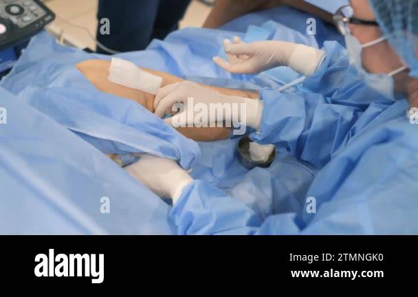 Surgical operation on the leg for varicose veins. A surgeon performs an ...