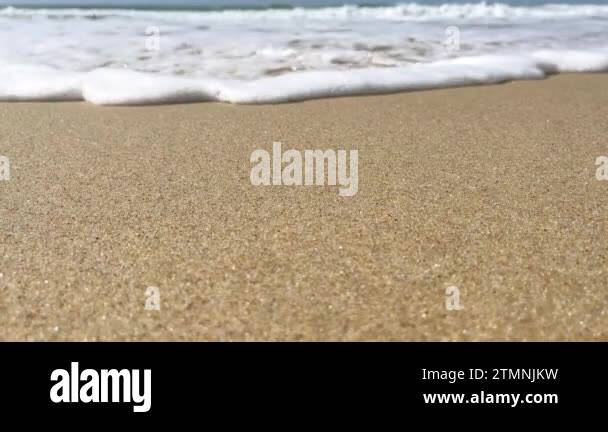 Top view 4K resolution video banner with sand, sea foam and waves ...