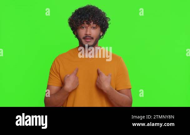 I am dont want it, not me. Confused young indian man pointing fingers ...