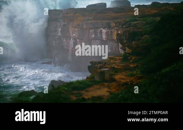 Storm surf breaking cliffs in super slow motion. Powerful waves ...