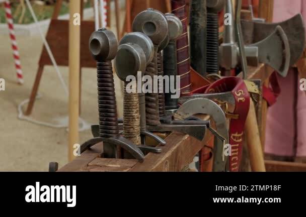 Medieval reenactment - reproduction real medieval steel weapons, swords axes and spears in a ...