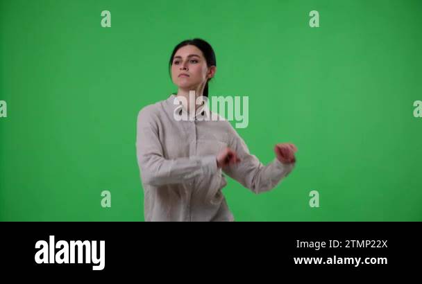 A vibrant and energetic Caucasian woman dances uninhibitedly on a green ...