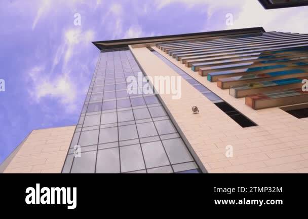 Narrow passage between modern residential buildings. Walls of high-rise ...