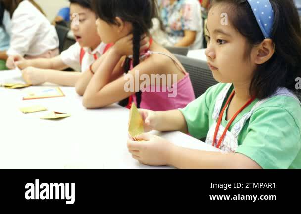 4K : Asian child learning to folding Japanese paper origami, art of ...