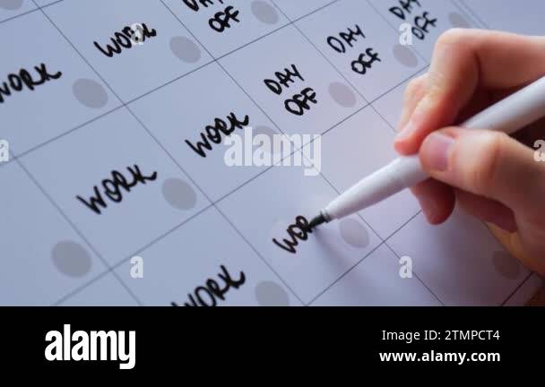 Unrecognizable person write on Magnetic board 4 day work week calendar ...