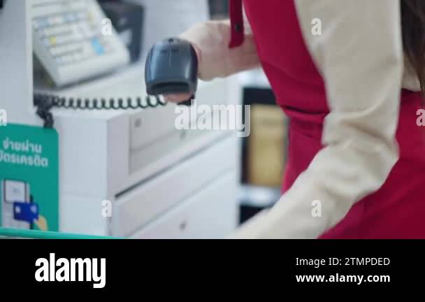 Cashier scanning items at supermarket checkout, close up scan item from ...