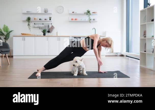 Happy caucasian woman improving balance with Side Plank Pose with ...