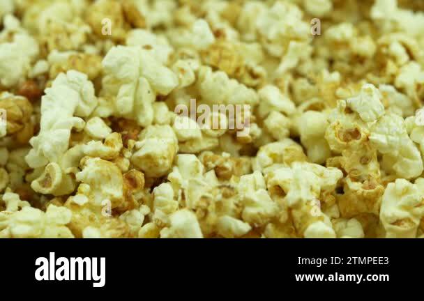 Freshly cooked popcorn with butter rotating. Popcorn background. Cinema ...