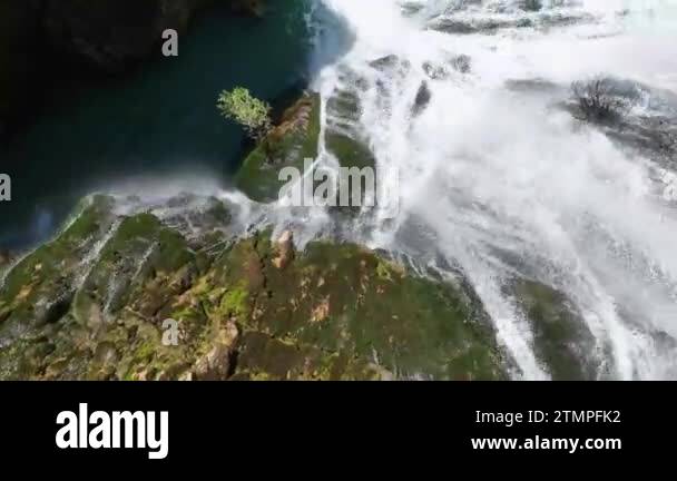 Immerse yourself in the mesmerizing elegance of the serene waterfall ...