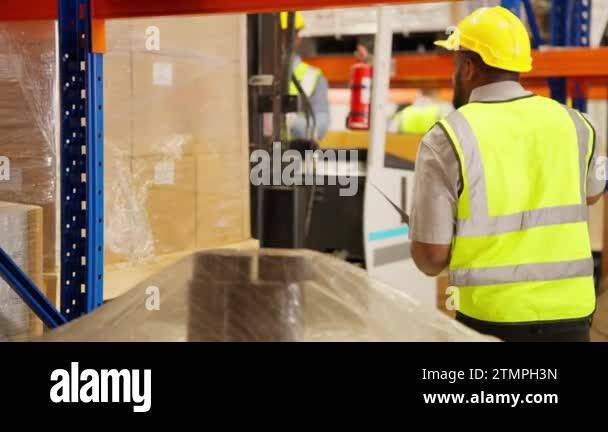 Warehouse workers checking and controlling boxes in warehouse ...