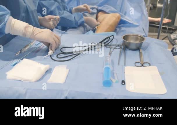 Surgical operation on the leg for varicose veins. A surgeon performs an ...