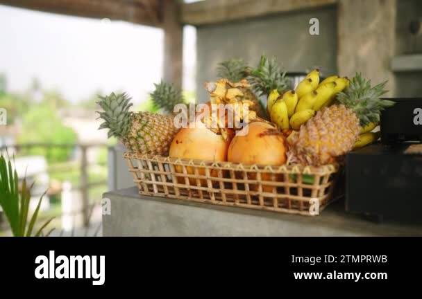 Basket with exotic fruit on a bar counter of an outdoor rooftop cafe ...