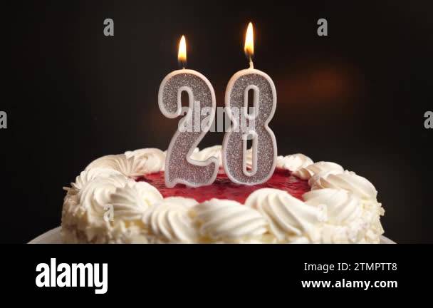 A candle in the form of the number 28, inserted into the holiday cake ...