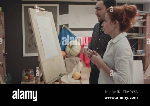 Female art teacher explaining student how to measure face proportions ...