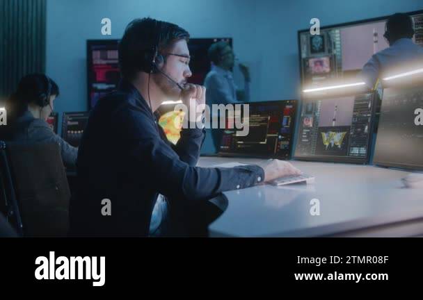 Flight control worker in headset monitors space mission with astronaut ...