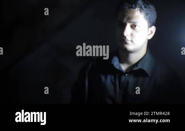 Cinematic shot of a mafia boss or a hitman sitting on a table in a ...