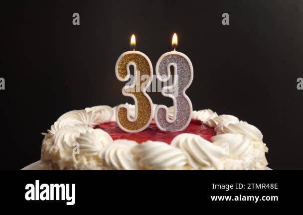 A candle in the form of the number 33, inserted into the holiday cake ...