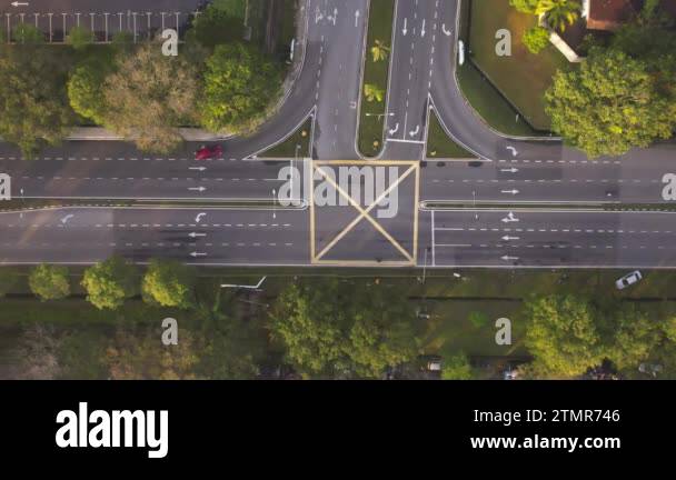 Top down aerial view of the red car moving on the road intersections in ...