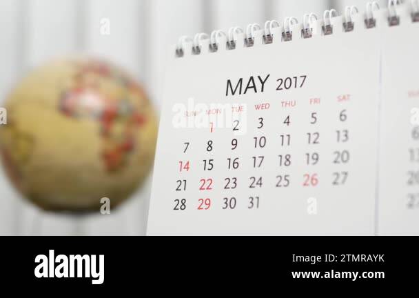 Motion of May 2017 calendar with blur earth globe turning background ...