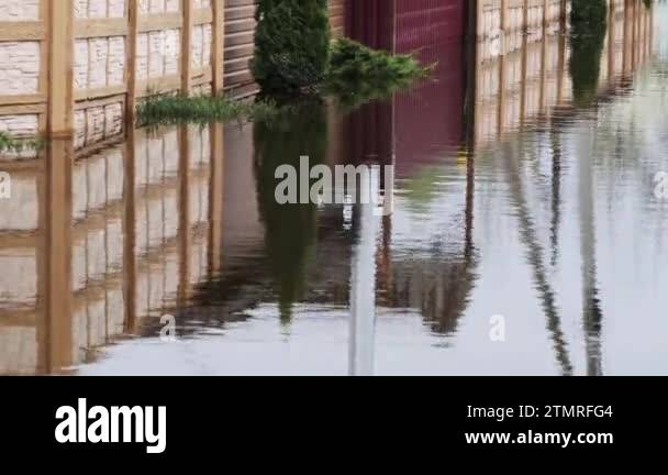 Flooding of private houses, flood in the village. Flooded roads, trees ...