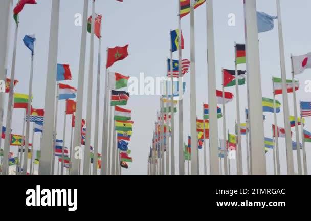 bottom view footage of flags of world waving on blue sky background ...