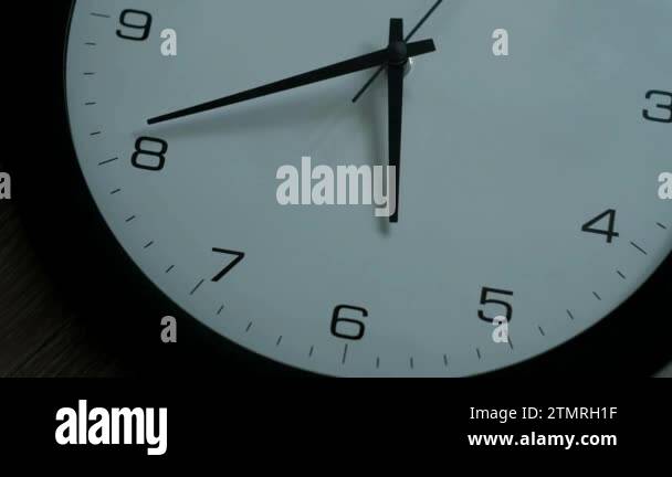 Close up a wall clock arrow showing hour and minute hand moving ...