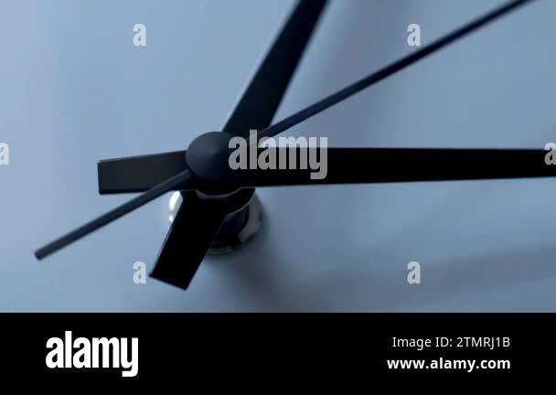 Close up a wall clock arrow showing hour and minute hand moving ...