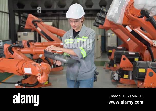 Maintenance engineer worker working with robotic machine automation at factory, Female ...