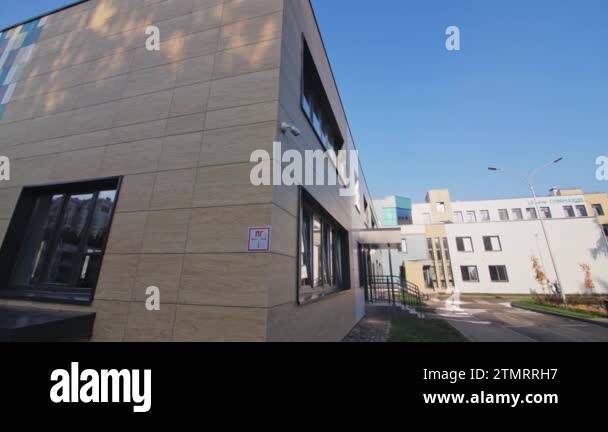 Surveillance camera on corner on modern school building. CCTV equipment ...
