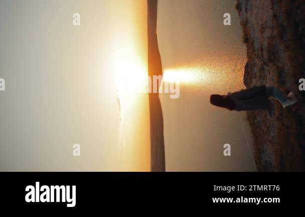 vertical video. The camera follows a female tourist who approaches the ...