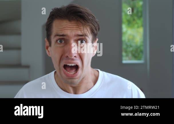 Frightened man screams in panic, seeing something terrible. Portrait of ...