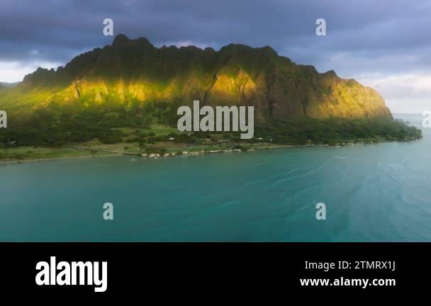 Cinematic sunrise light shining at Kualoa Ranch mountain range, Oahu ...