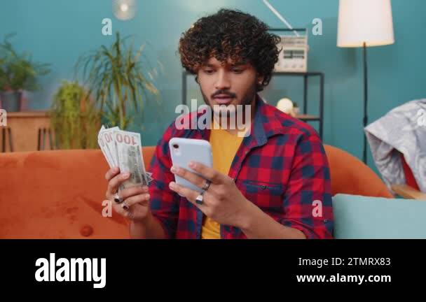 Planning family budget. Smiling indian man counting money cash, use ...