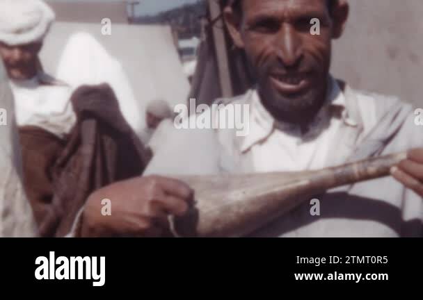 Morocco happy man playing traditional instrument in rural market. Close ...