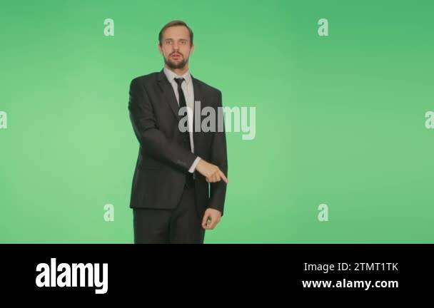 body language. a man in a business suit on a green background, hromakey ...